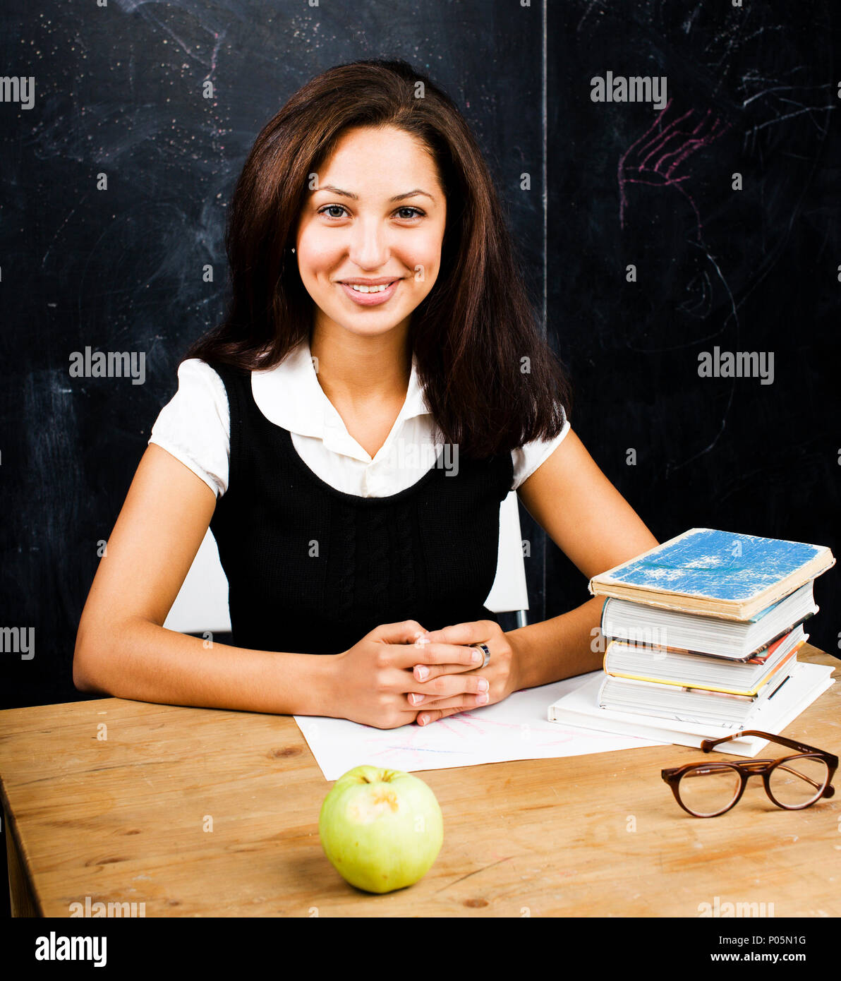 portrait of happy cute student in classroom at blackboard back to ...