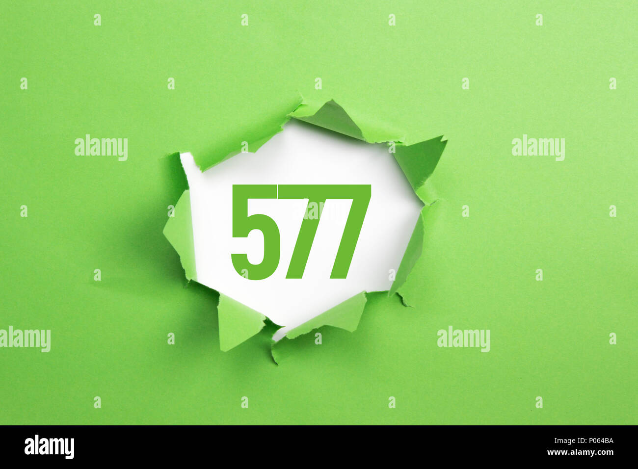 Green Number 577 on green paper background Stock Photo - Alamy