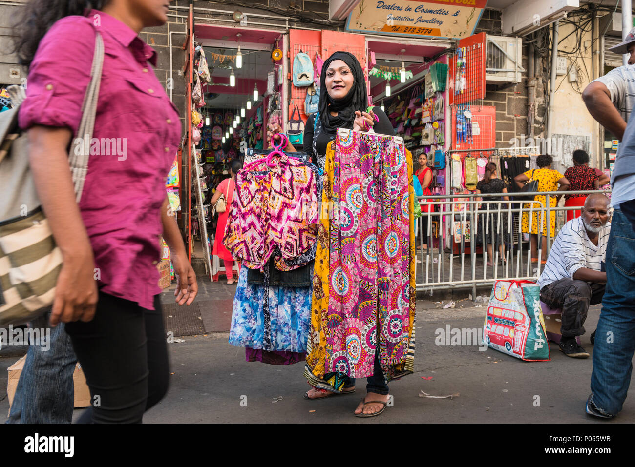 Woman street vendor selling clothes in a street market in downtown Port ...
