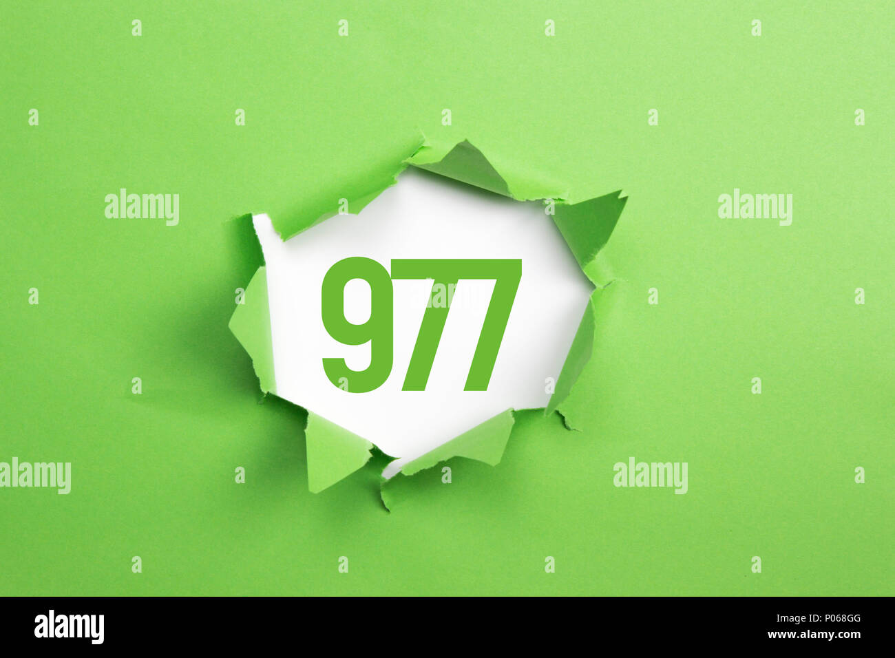 Green Number 977 on green paper background Stock Photo - Alamy