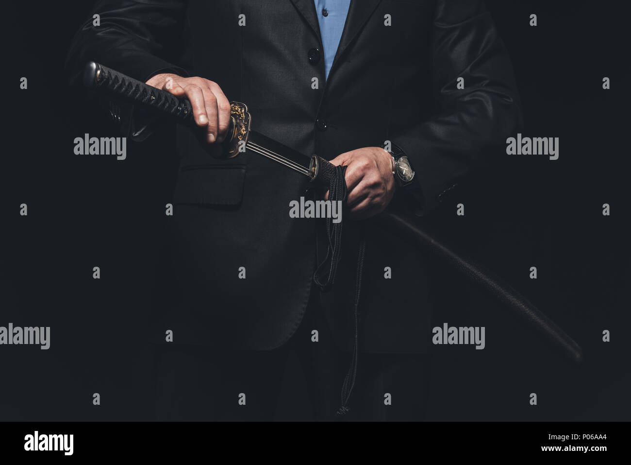 cropped shot of man in suit taking out his katana sword isolated on ...