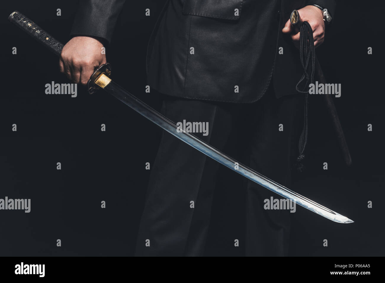 cropped shot of man with katana sword on black background Stock Photo ...