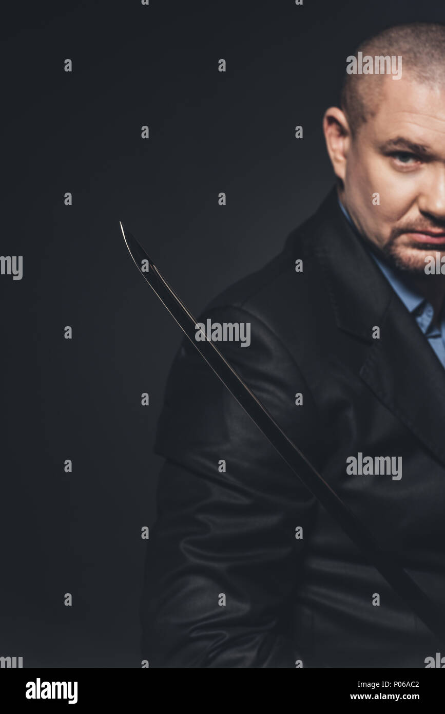 close-up shot of modern samurai with katana sword on black Stock Photo ...
