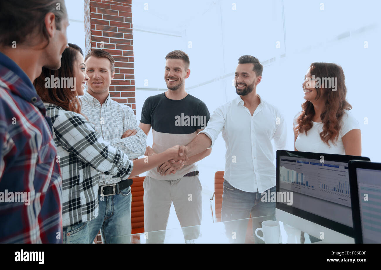 friendly handshake partners in creative office Stock Photo - Alamy