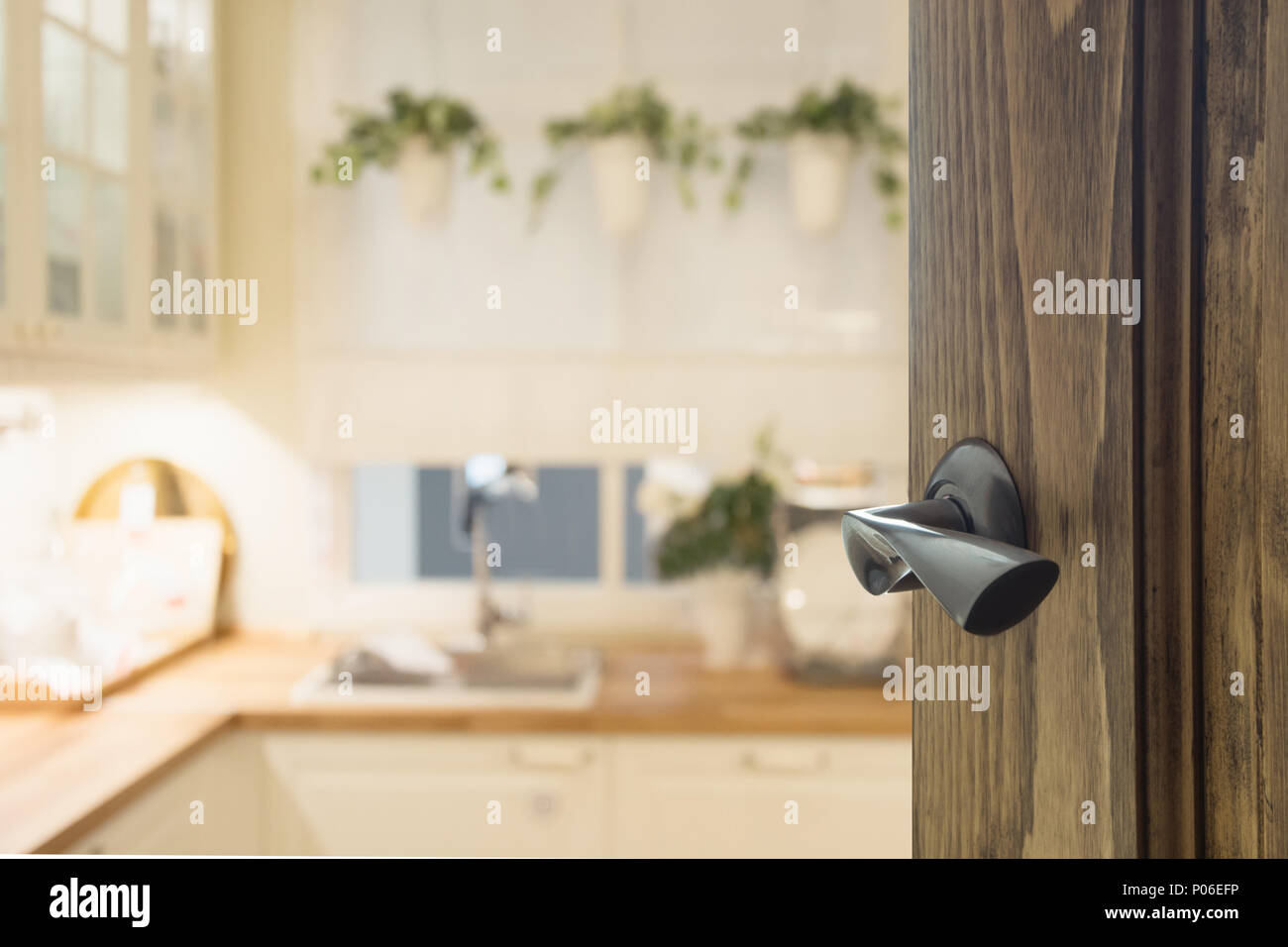 Opened wooden door to modern kitchen interior for background Stock ...