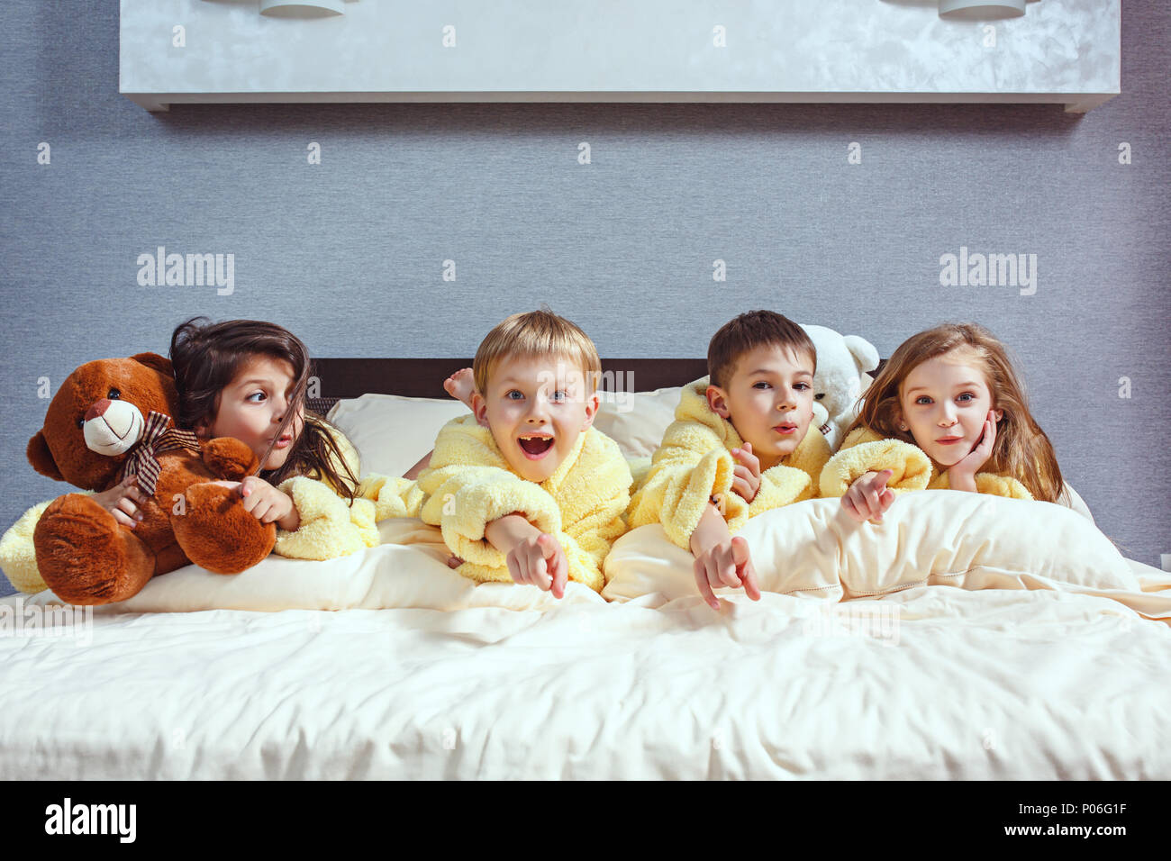The group of friends taking goog time on bed Stock Photo - Alamy
