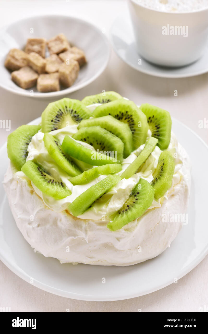 Pavlova meringue cake with kiwi slices and whipped cream Stock Photo ...
