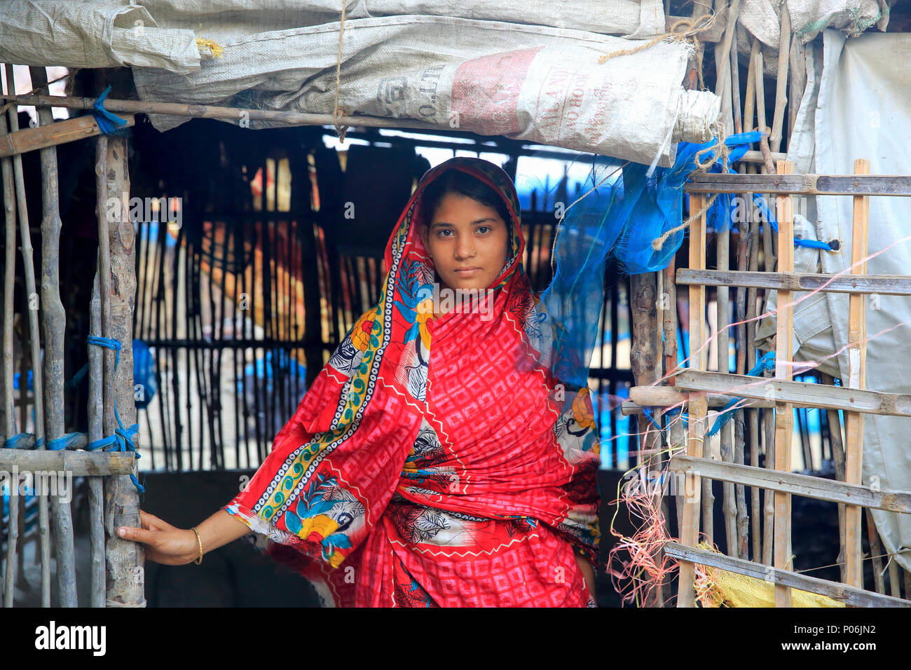 A woman stands inside her hut at at cyclone Aila effected Gabura, a ...