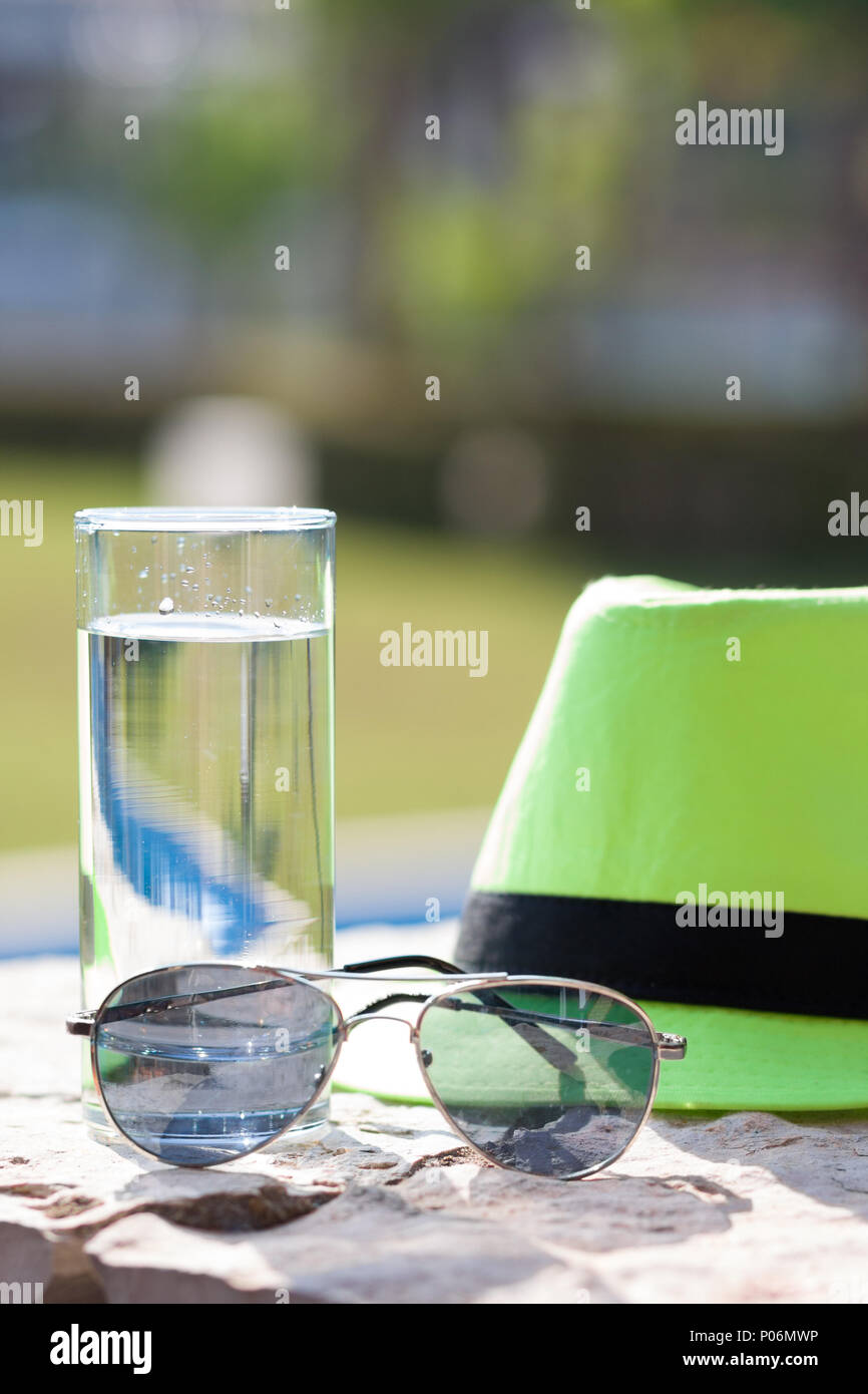 Sunglasses and glass of water in summer Stock Photo - Alamy