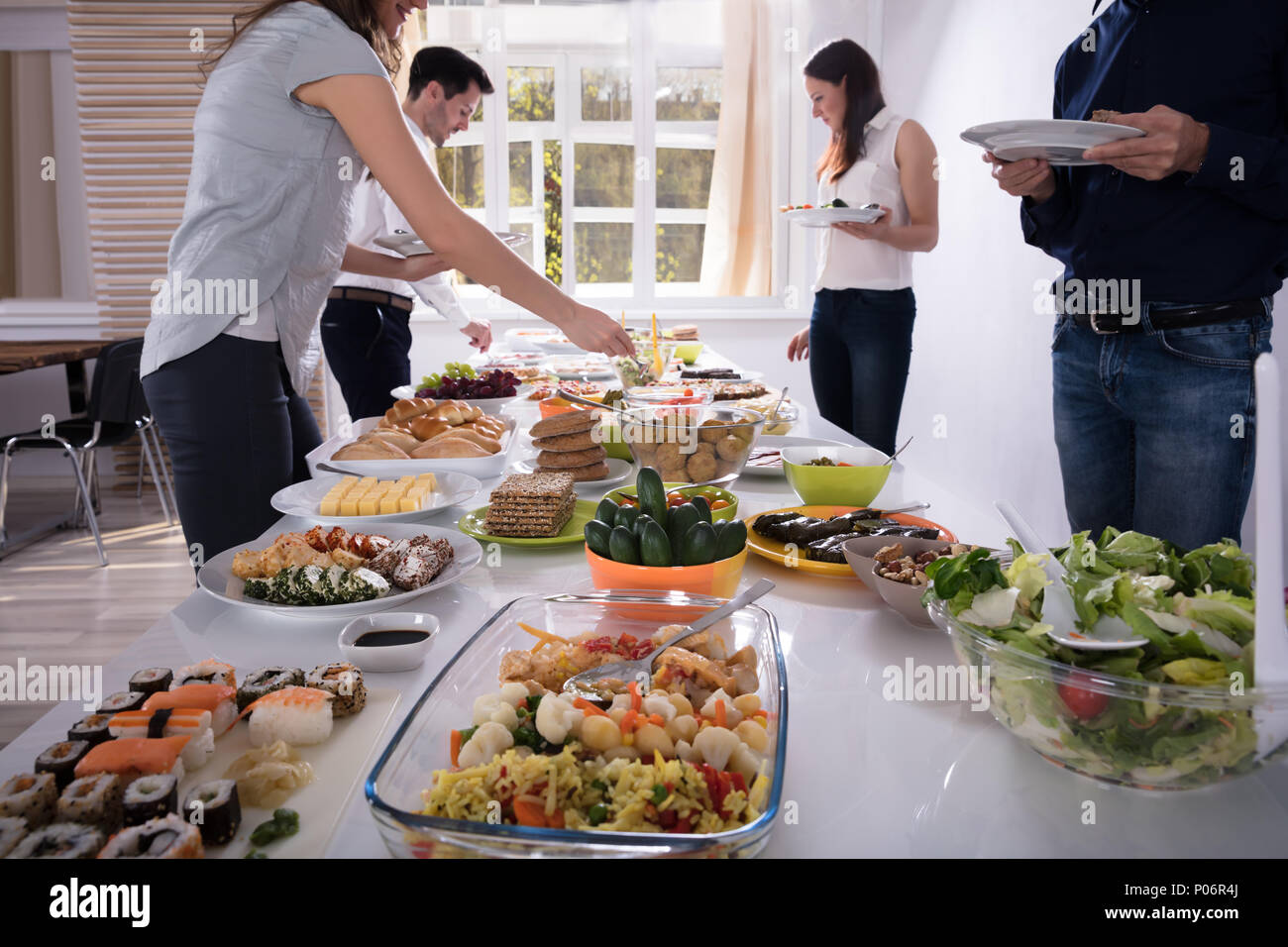 People's Hand Picking Fresh Food Over Table At Party Stock Photo - Alamy