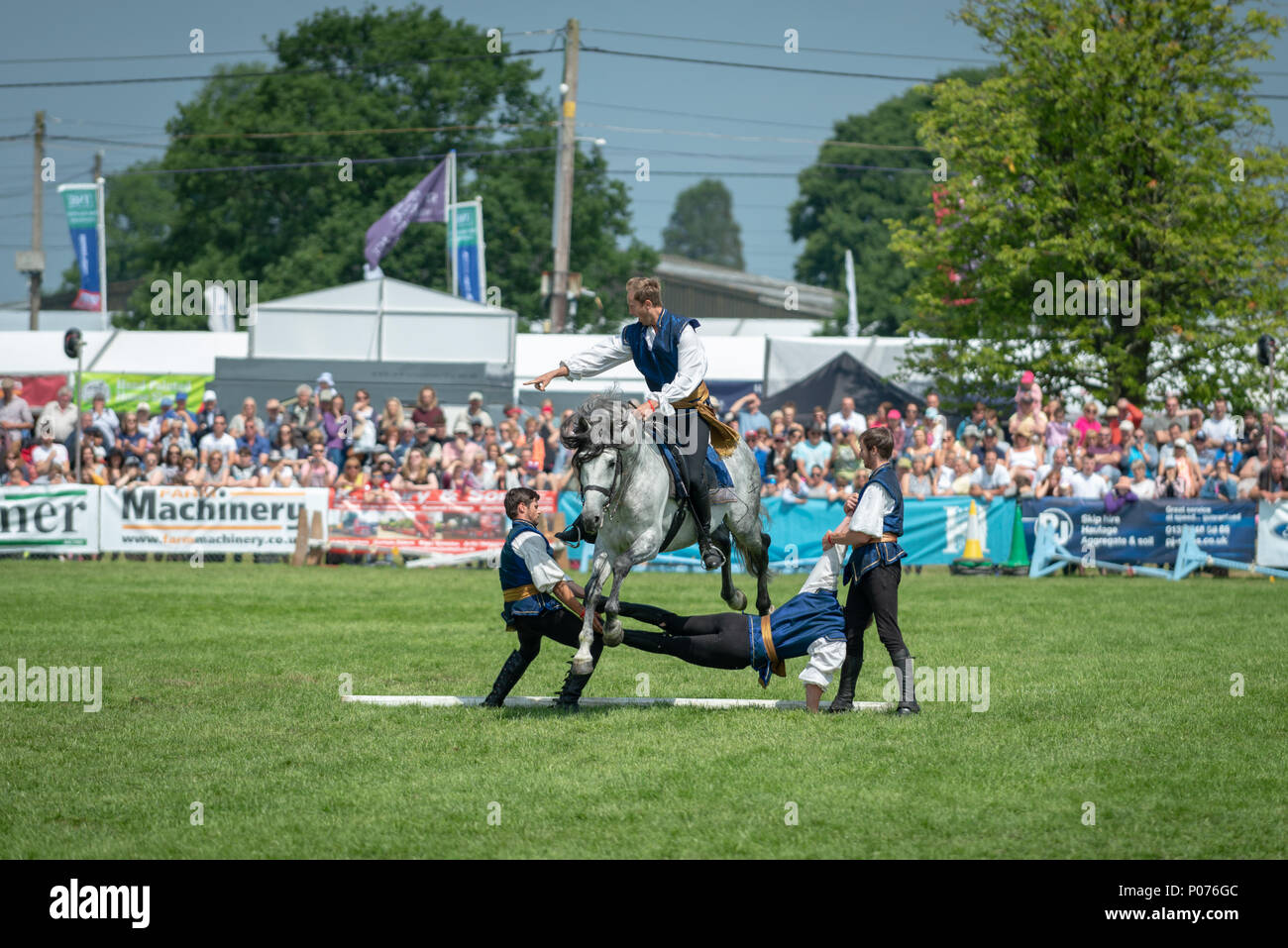 While riding a horse, a rider from the Atkinson Action Horses jumps ...
