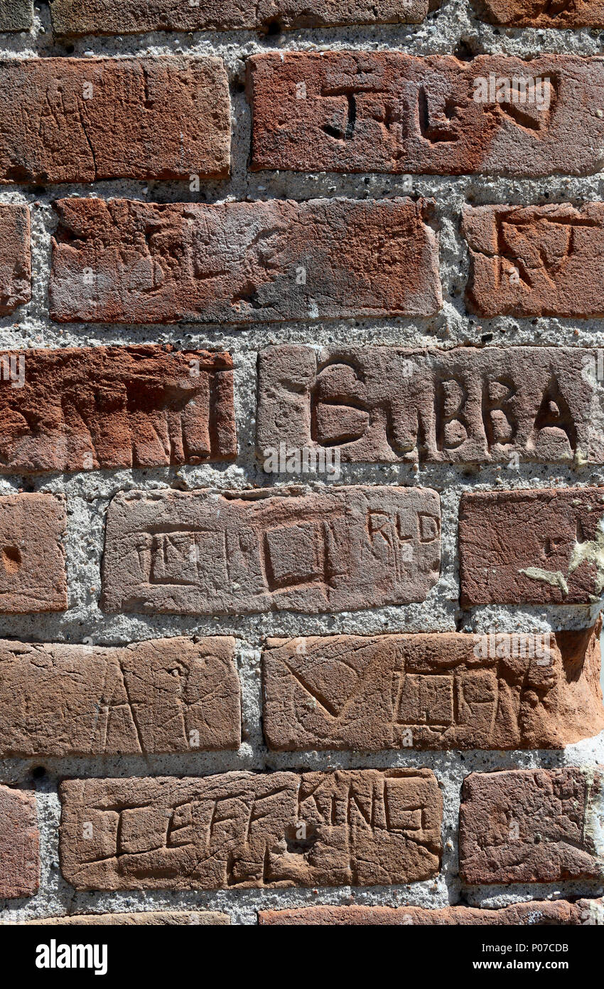 Red brick wall with multiple names embedded in the brick Stock Photo ...