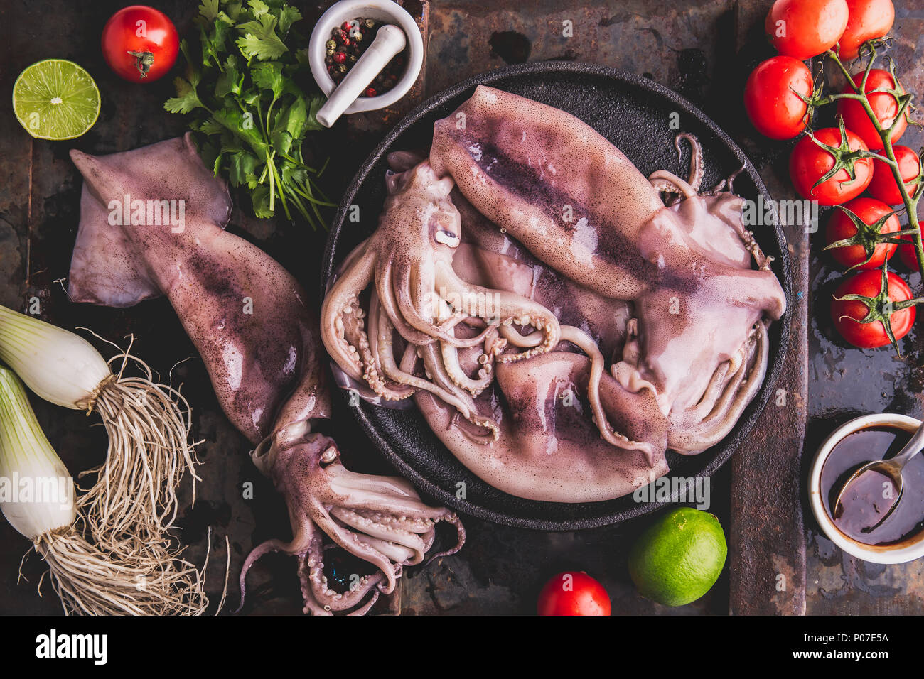 Seafood squid calamary. Fresh raw whole squid with tentacles on black ...