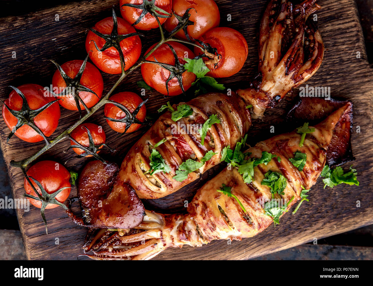 Korean BBQ squid calamary and ingredients on dark background ...