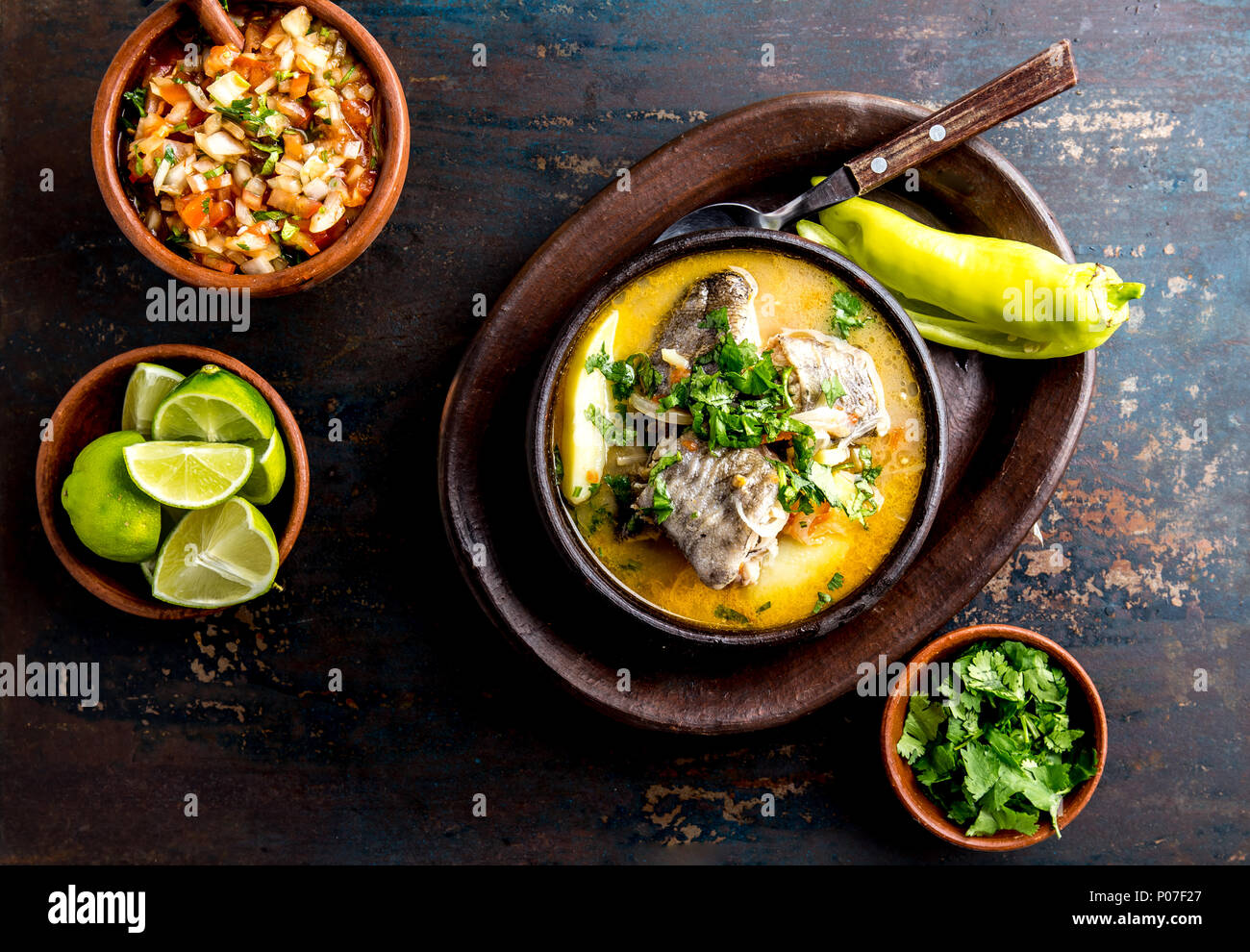 CHILEAN FOOD. Fish soup CALDILLO DE CONGRIO served in clay bowl, top ...