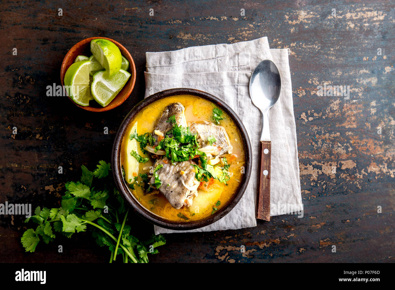 CHILEAN FOOD. Fish soup CALDILLO DE CONGRIO served in clay bowl, top ...