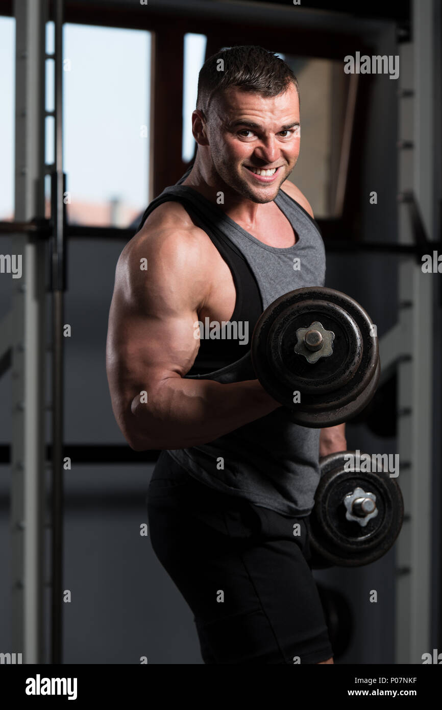 Athlete Working Out Biceps In A Gym - Dumbbell Concentration Curls ...