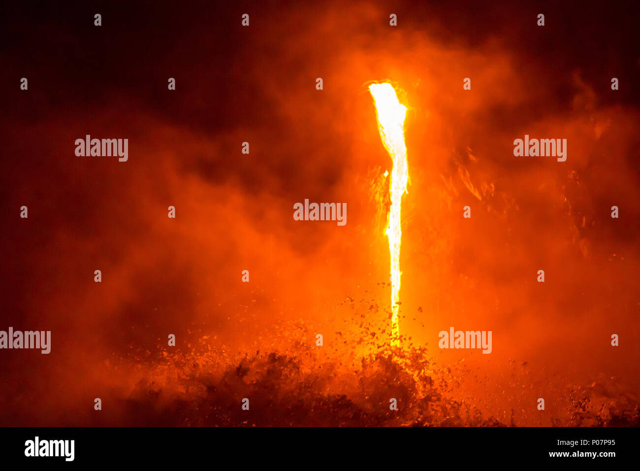 A stream of molten lava dripping into the ocean in Hawaii Stock Photo ...