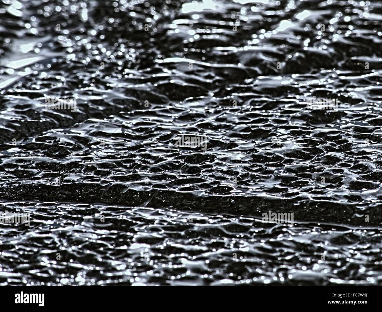 Detail of frozen icy sheet. Ice cracks forming surface, floes flowing ...