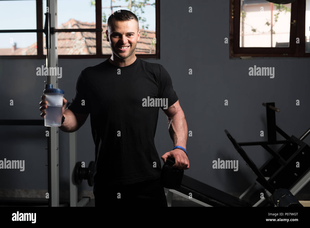 Muscular Man Resting After Exercise And Drinking From Shaker Stock ...