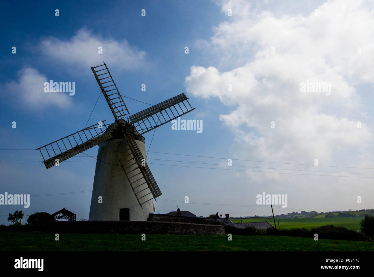 White Windmill against a blue sky Stock Photo - Alamy