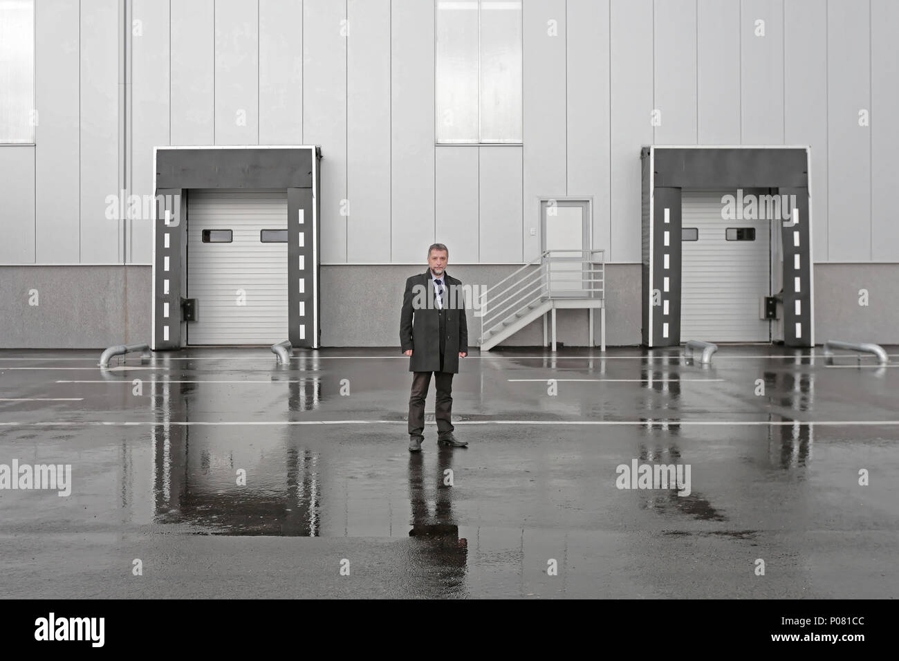 Businessman in Front of Distribution Warehouse Loading Dock Stock Photo ...