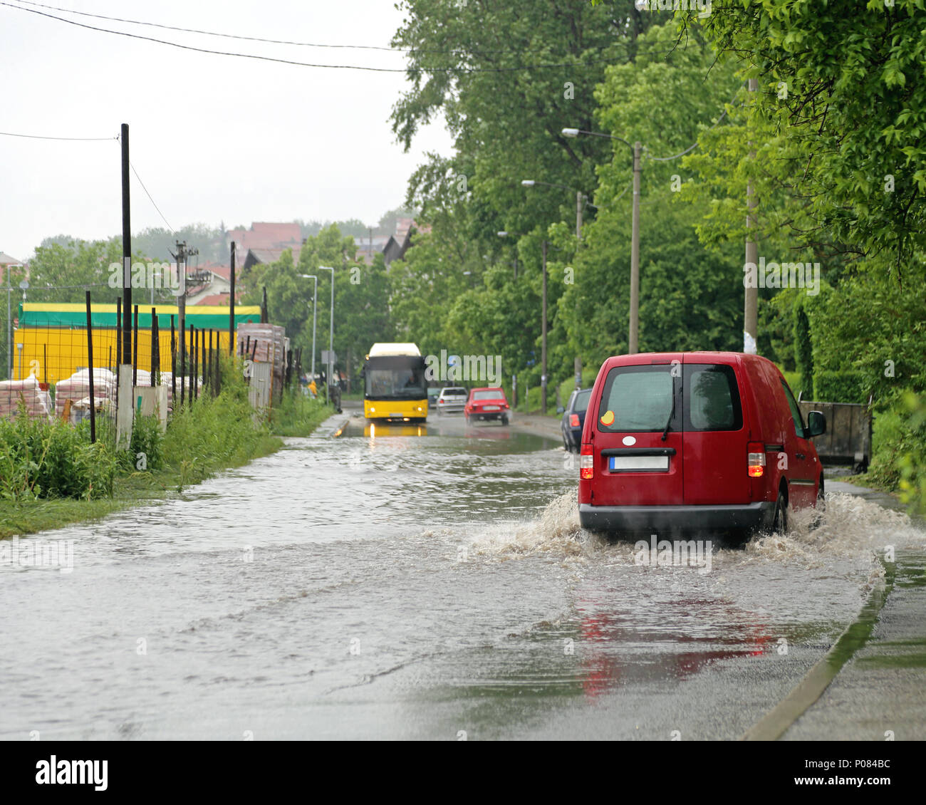 Vehicles driving through flood water hi-res stock photography and ...