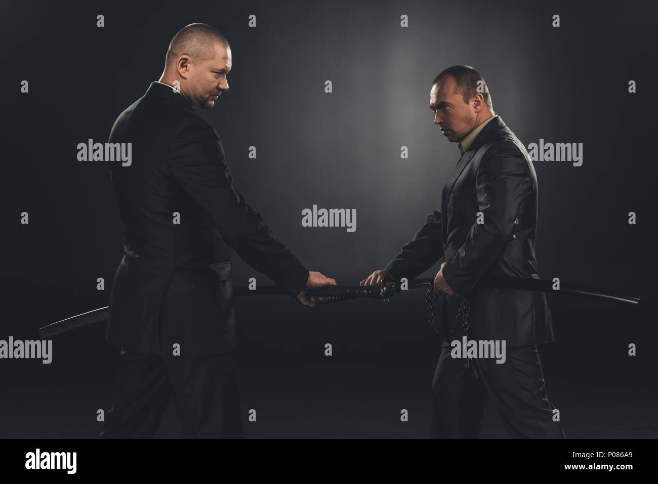 side view of businessmen taking out katana swords for fight isolated on ...