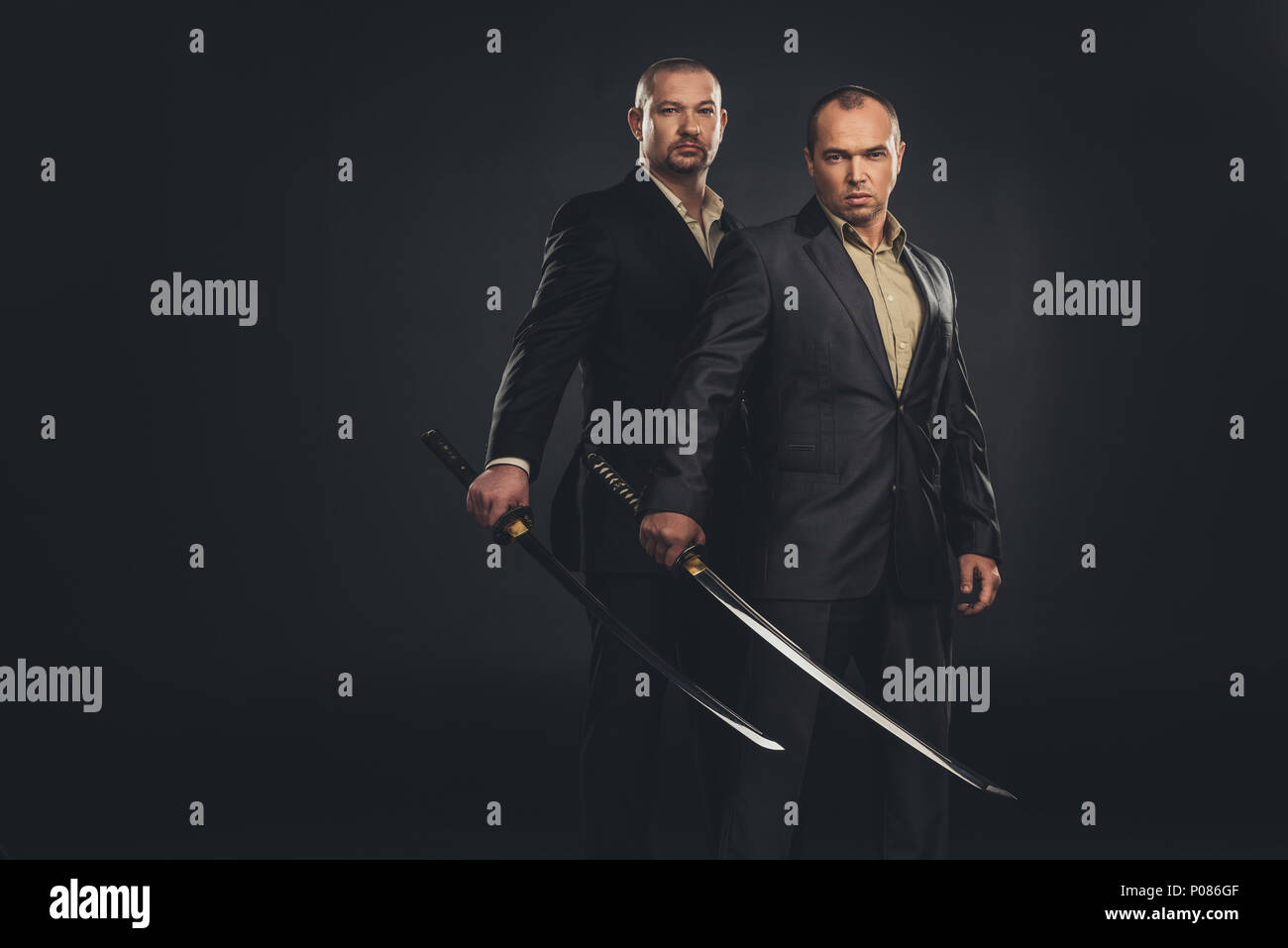 modern samurai with katana swords isolated on black Stock Photo - Alamy
