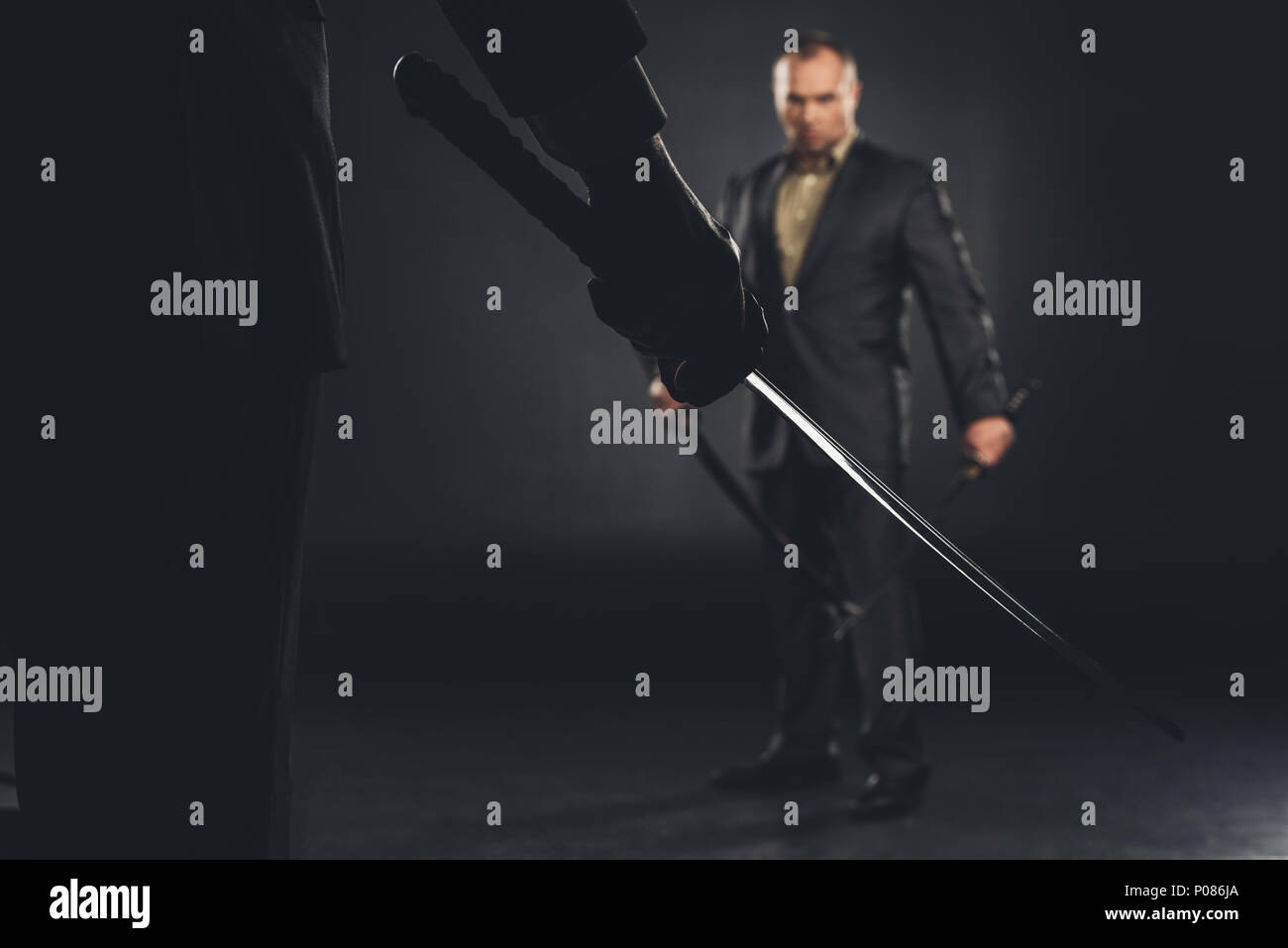 handsome modern samurai in suit ready to fight on black Stock Photo - Alamy