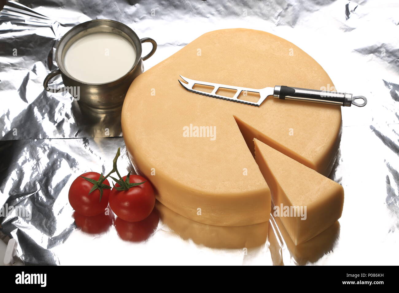 A sliced cheese wheel Stock Photo - Alamy