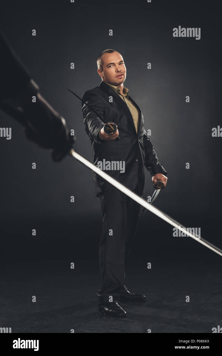 modern samurai in suit ready to fight on black Stock Photo - Alamy