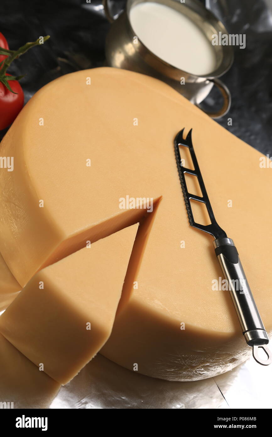 A sliced cheese wheel Stock Photo - Alamy