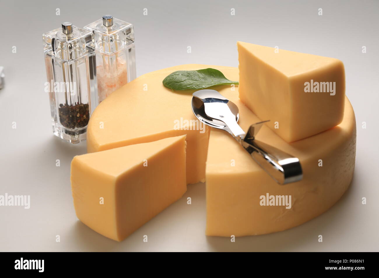 A sliced cheese wheel Stock Photo - Alamy