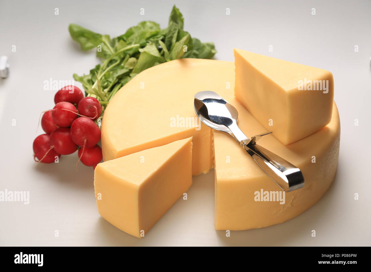 A sliced cheese wheel Stock Photo - Alamy