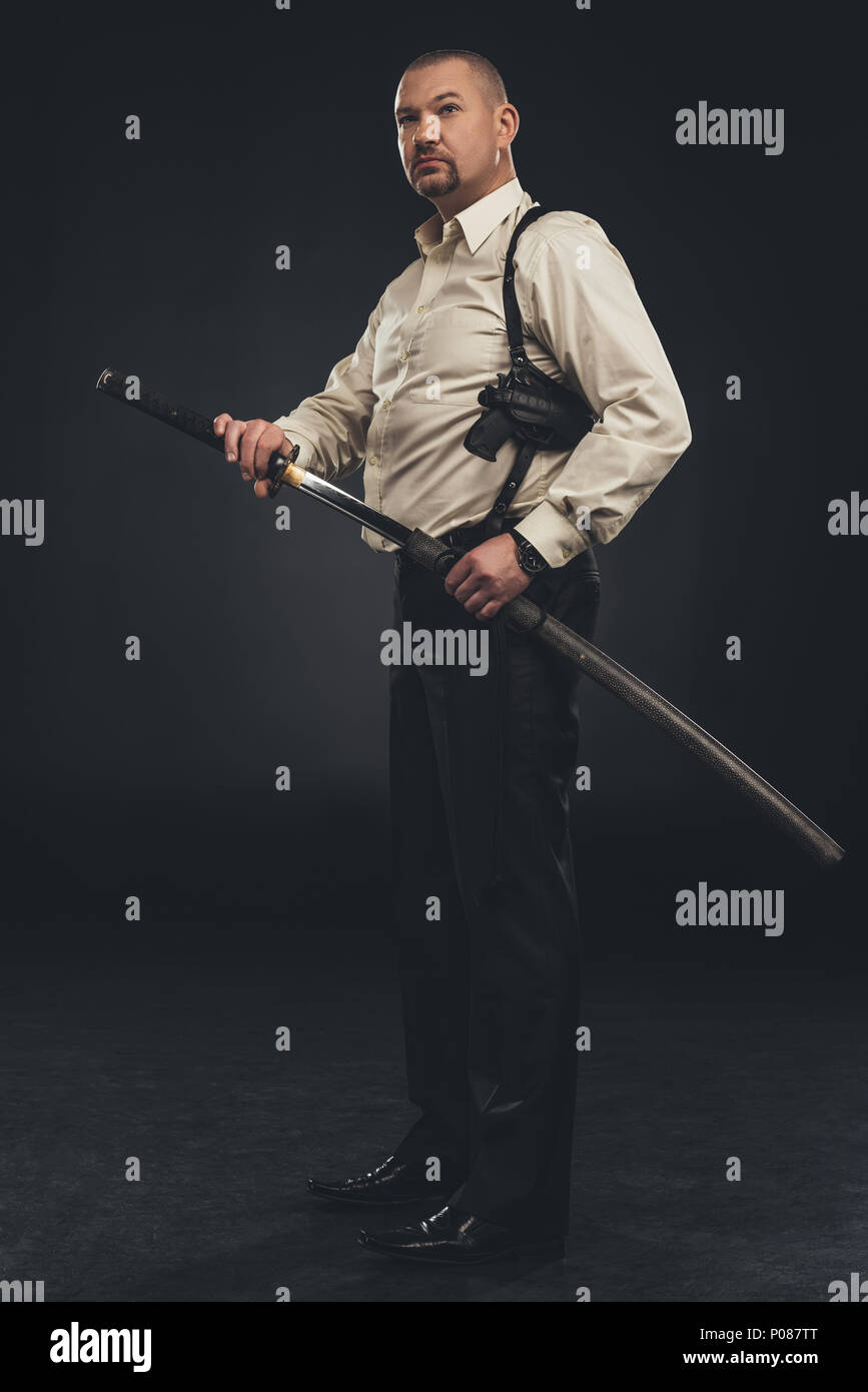 side view of yakuza member taking out his katana sword Stock Photo - Alamy