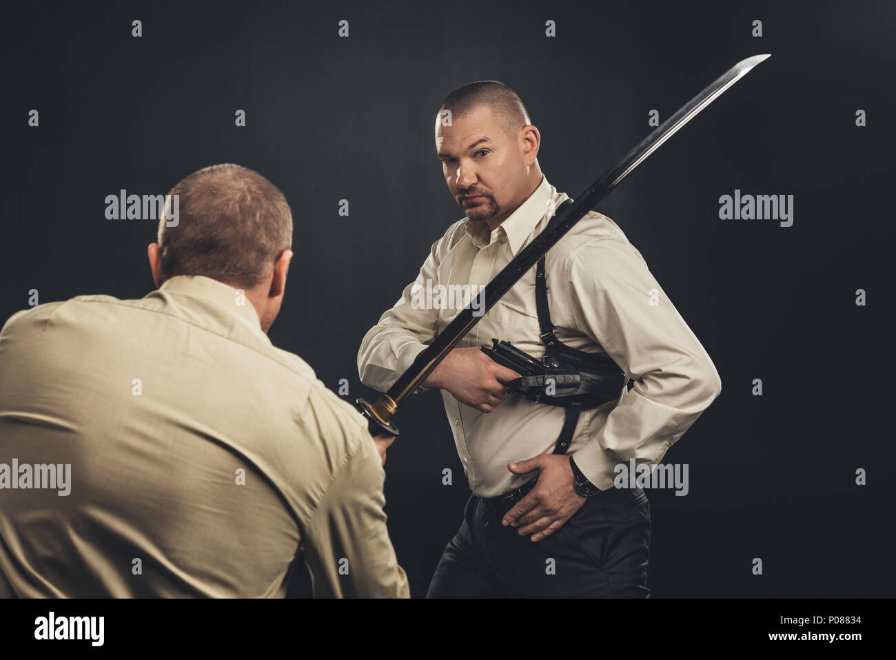 mafia members fighting with gun and katana sword on black Stock Photo ...