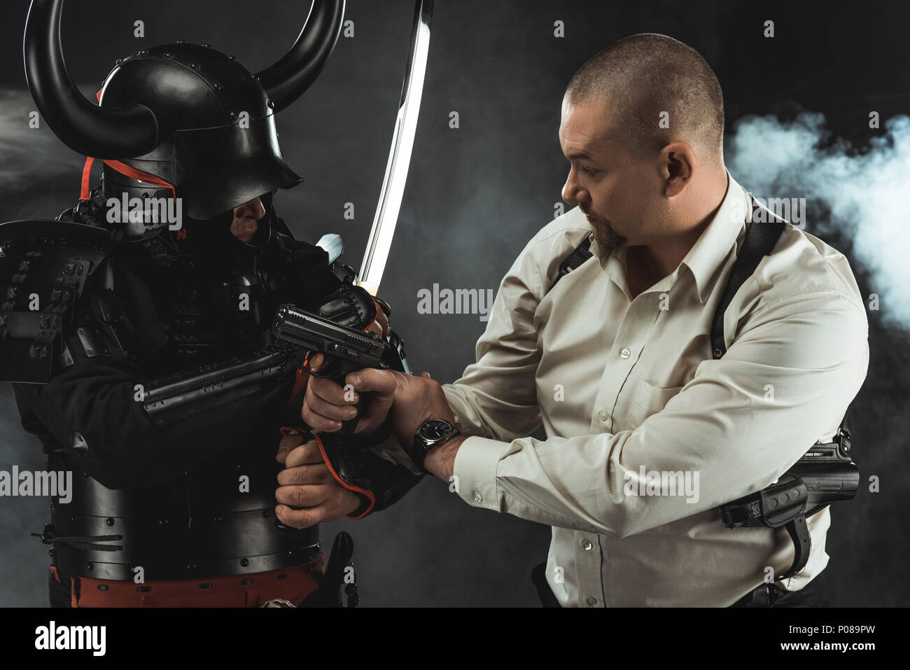 armored samurai fighting with modern man in shirt who holding gun Stock ...