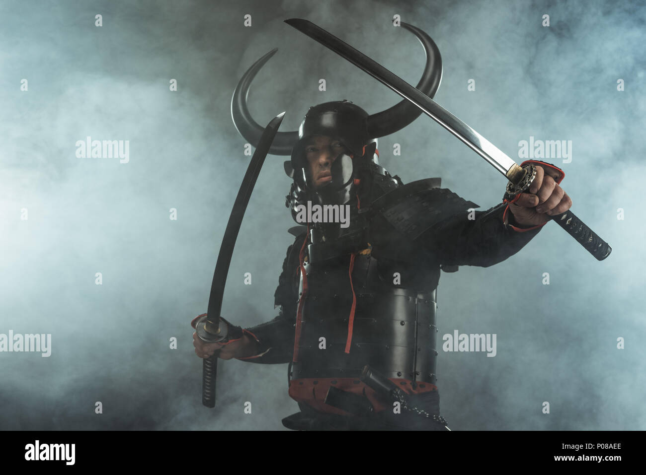 samurai in traditional armor with dual katana swords in defence ...