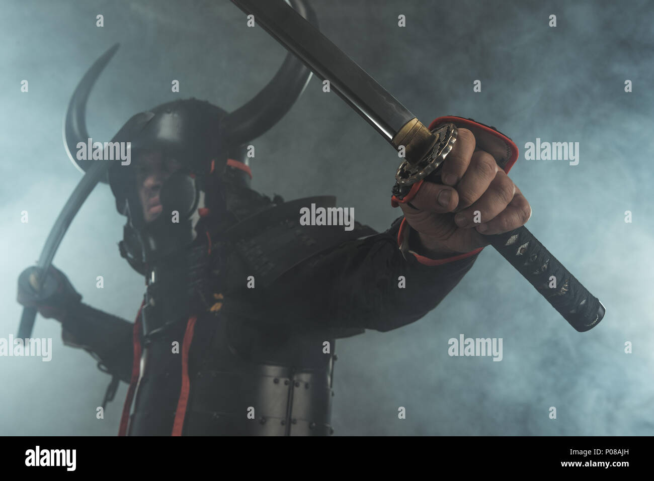 close-up shot of samurai in armor with dual katana swords on dark ...