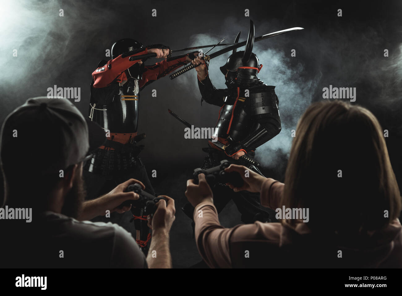 rear view of man and woman playing samurai fighting in real life with ...