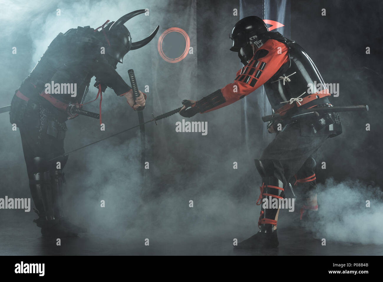 armored samurai fighting with swords surrounded with smoke in front of ...