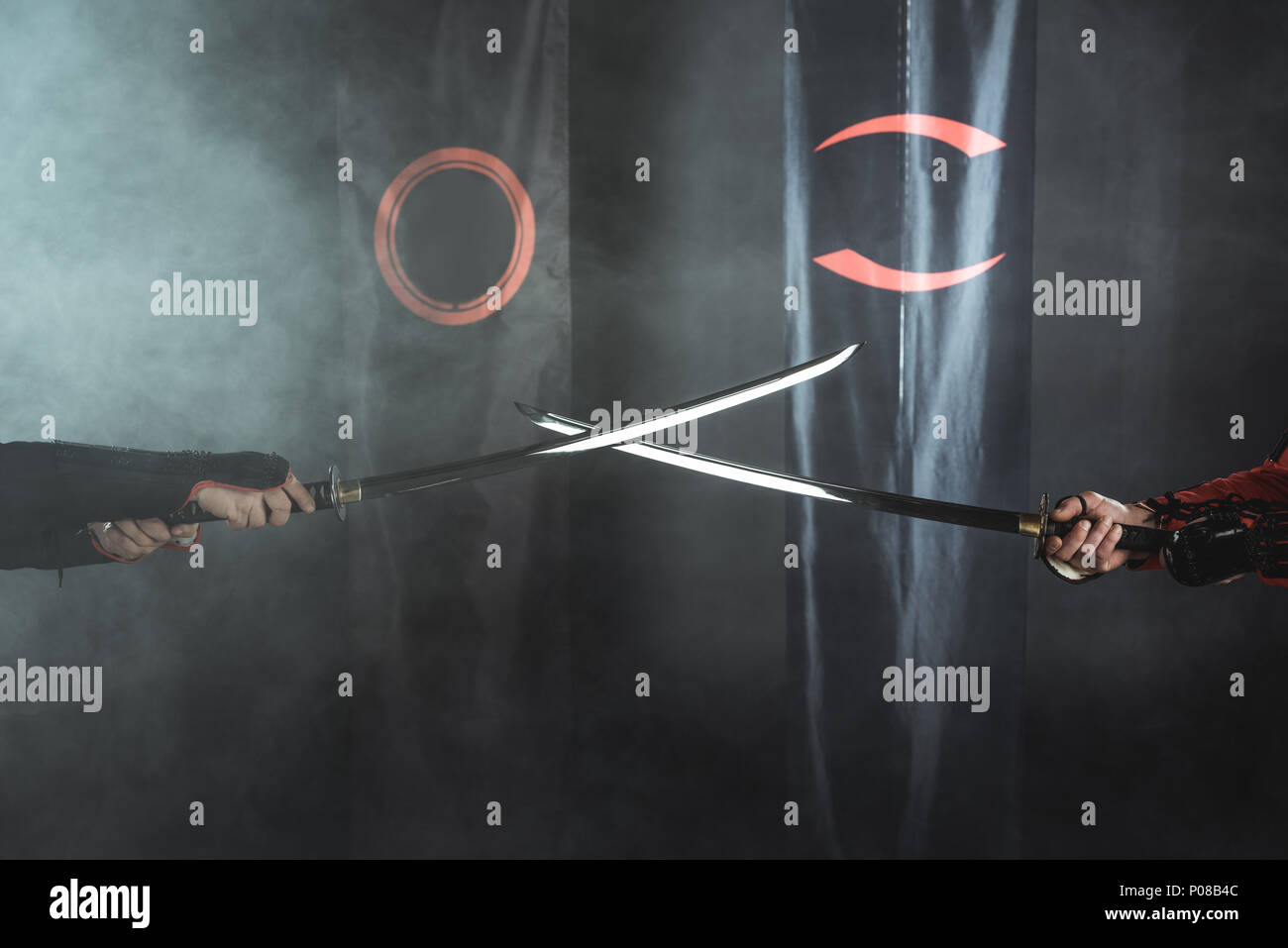 cropped shot of samurai warriors crossing katana swords in front of ...