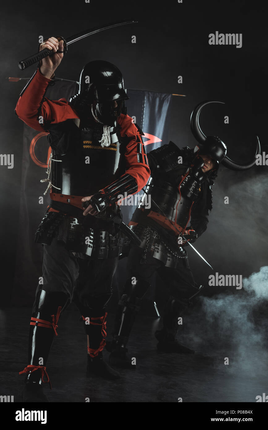 armored samurai fighting with swords in front of clan symbols on flags ...
