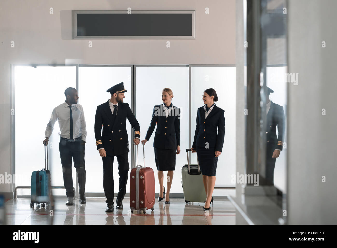 aviation personnel team walking by airport loggy Stock Photo - Alamy