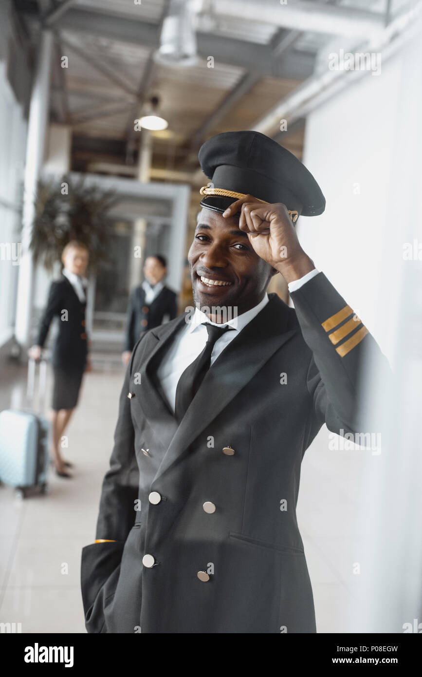 happy young pilot in airport looking at camera Stock Photo - Alamy