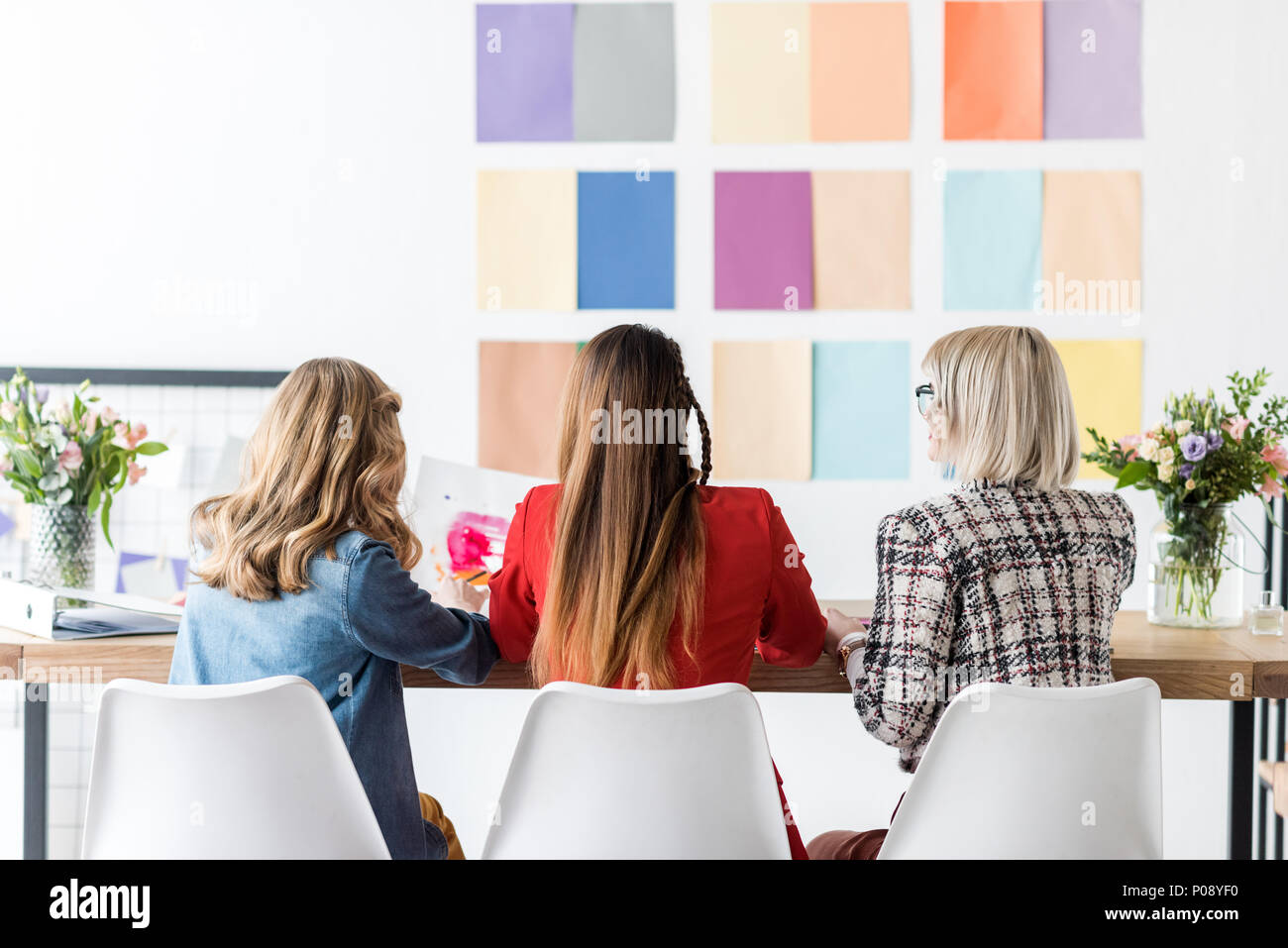 back view of magazine editors working with color palette an wall Stock ...