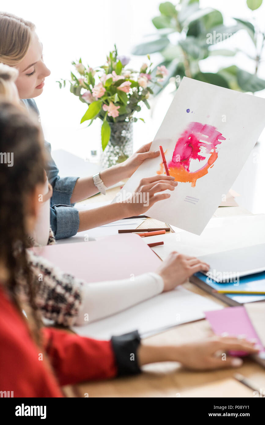 fashionable magazine editors working with sketch in modern office Stock ...