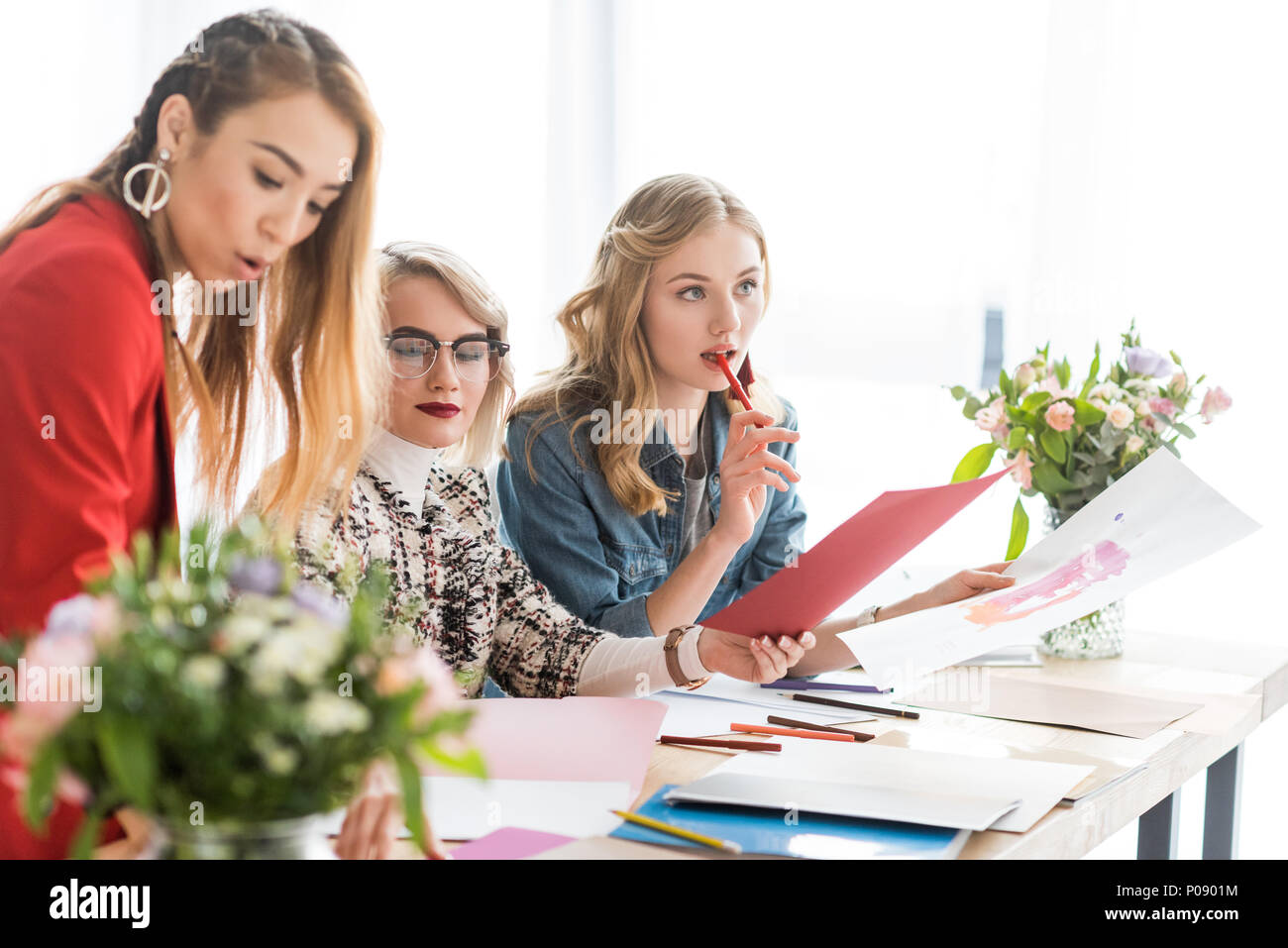 multiethnic magazine editors working with color palette in modern ...