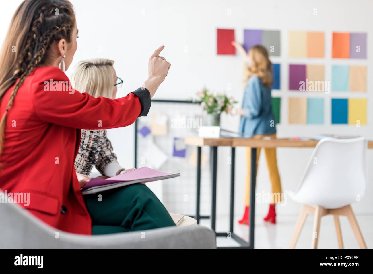 magazine editor pointing at color palette in modern office Stock Photo ...